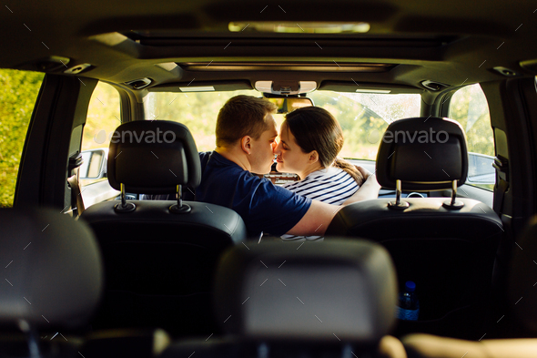 Smiling young couple inside a car. Kissing in the car Stock Photo by ...