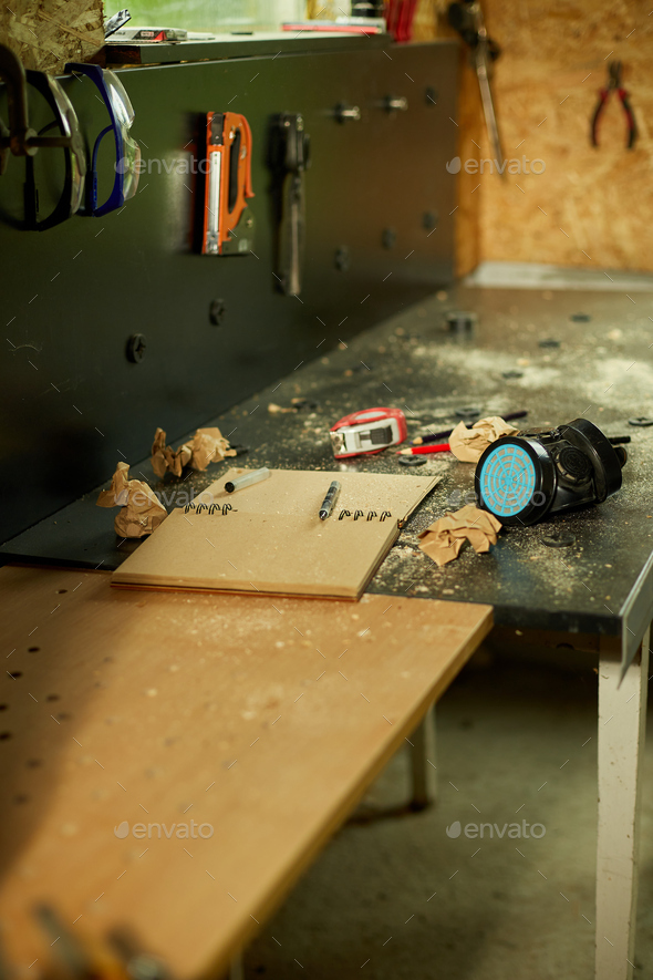 Carpenter workplace with notepad and power working tools graver for ...
