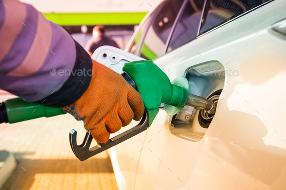 Refueling the car at a gas station fuel pump Stock Photo by AtlasComposer