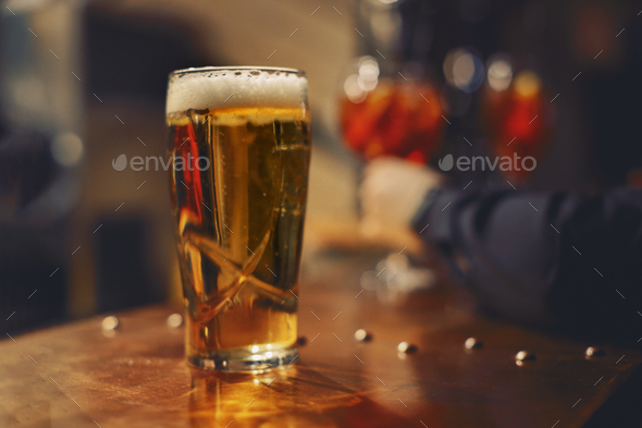 Pint of beer at the bar in a traditional pub. Stock Photo by dasha11