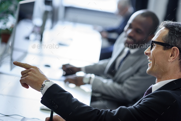 selective focus of multicultural businessmen having conversation at ...