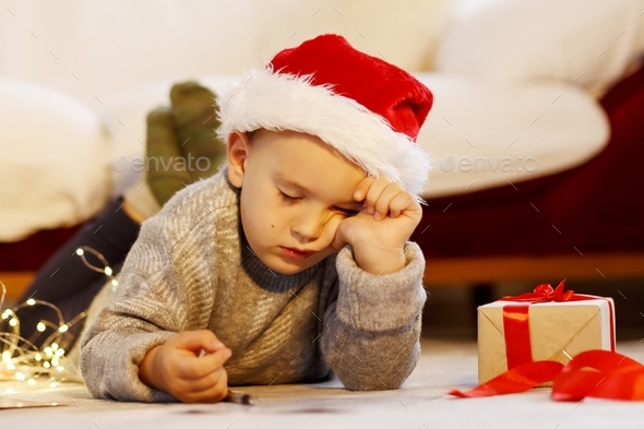 Little boy fall asleep,while waiting presents from Santa In Christmas ...