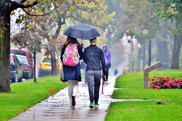 College students on campus in the rain using umbrellas Stock Photo by ...