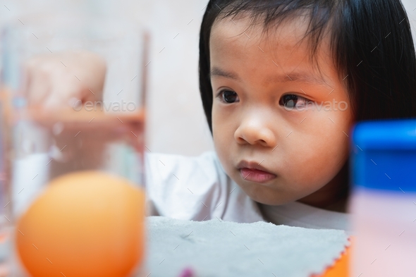 Cute girl doing a simple science experiment, the floating egg ...