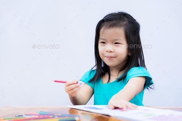 Children are doing coloring activity with color pencil crayon on ...
