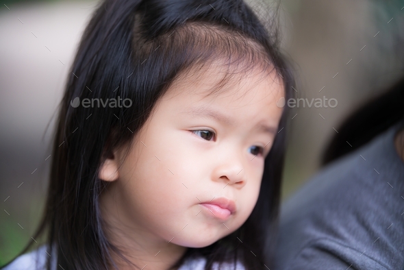 Closeup of a cute Asian girl's face is getting bored. Stock Photo by ...
