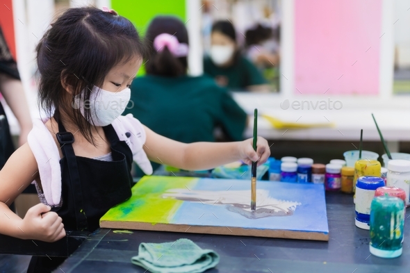 Kindergarten child happy girl learning art watercolor in classroom ...