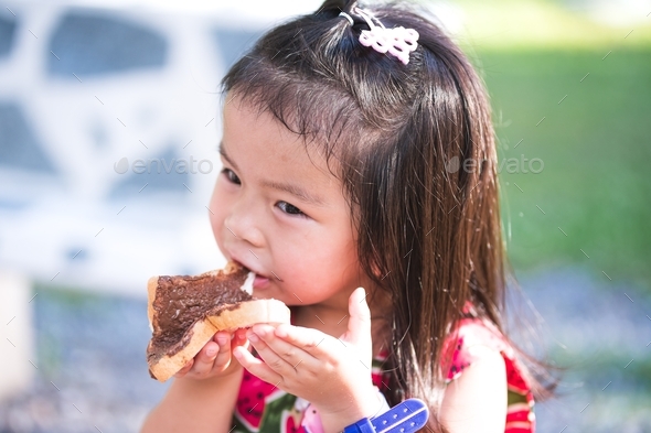 Adorable kid enjoying delicious chocolate-covered bread. Hungry ...