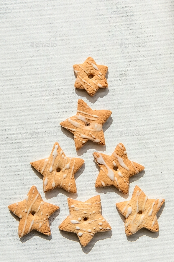 shortbread cookies in the shape of stars with drops of glaze on a white ...