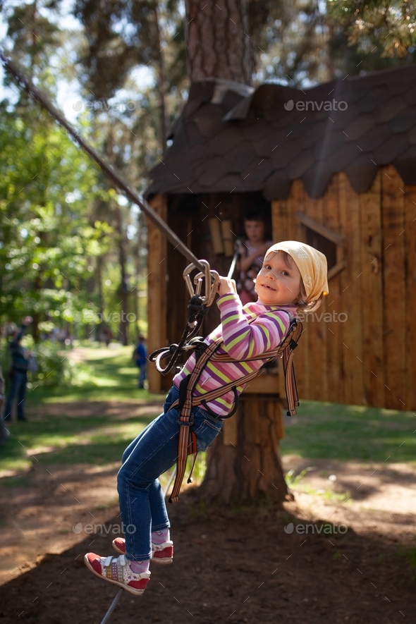 little girl climbs in the rope park. girl scout Stock Photo by yuliia ...