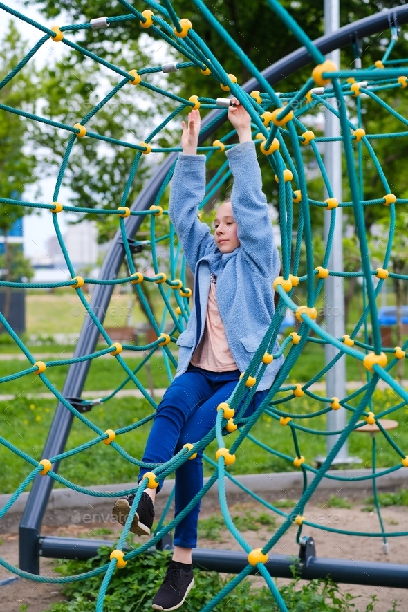 A middle school age teenager girl in a rope park. Joy and fun. Hobby ...
