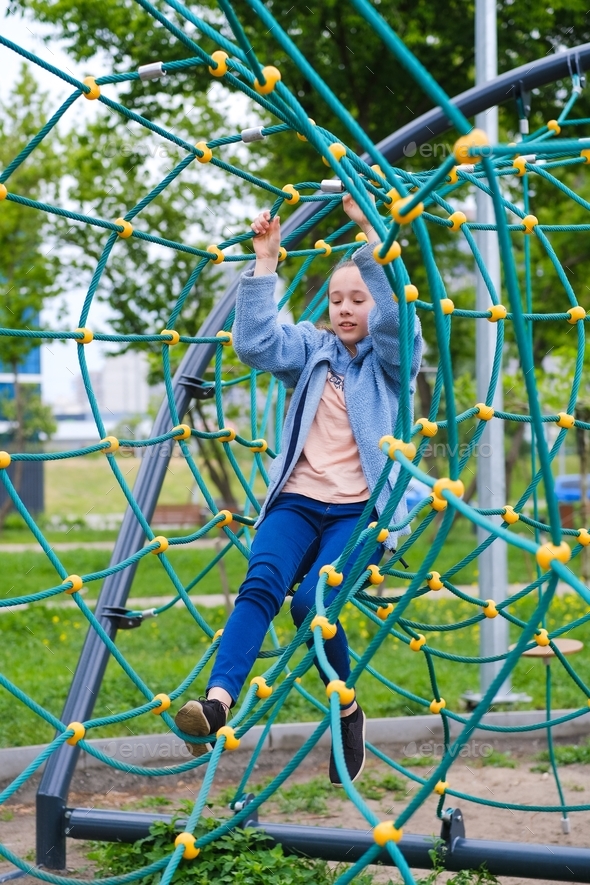 A middle school age teenager girl in a rope park. Joy and fun. Hobby ...