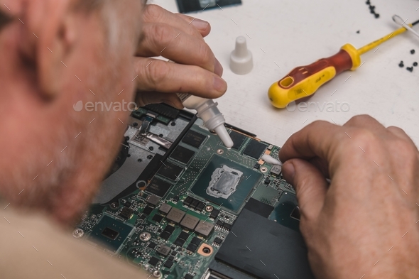 Cleaning and replacing the old thermal paste with new one on the ...