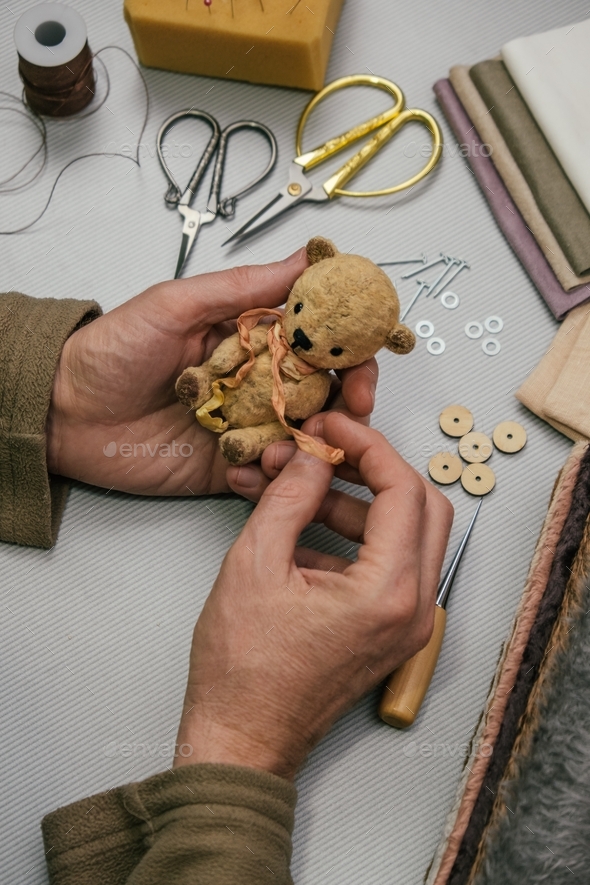 Teddy master man holds hand-sewn teddy bear in his hands. Small ...