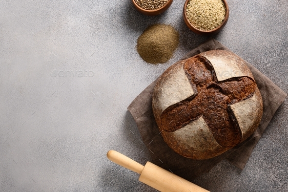 Loaf of artisan hemp bread with organic seeds and flour on gray ...