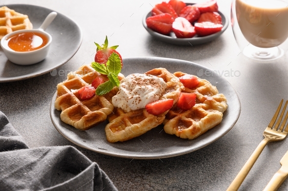 Croffle for breakfast or croissant waffle with strawberries and whipped ...