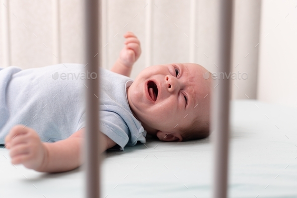 The baby is crying in his crib Stock Photo by aliona2194 | PhotoDune