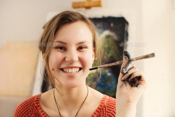 Portrait of beautiful woman artist with smile and positive emotion in ...