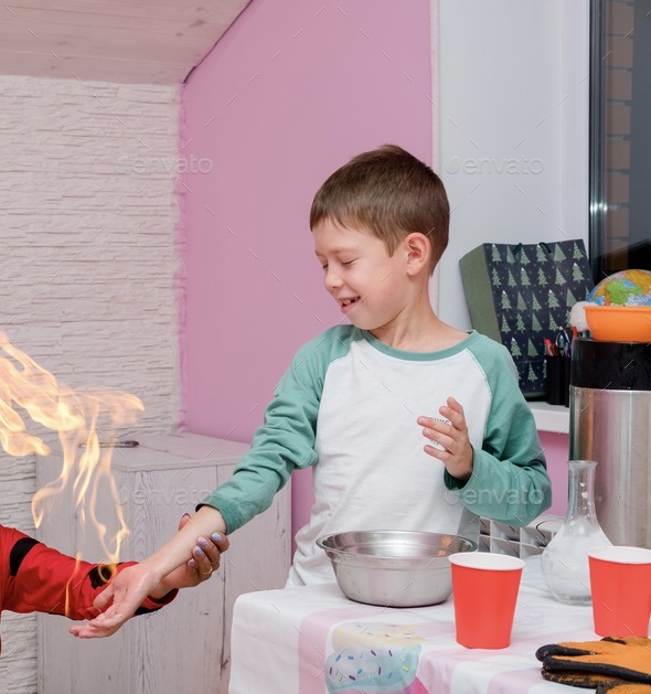 boy holding fire in his hands. Special effects with fire and children ...