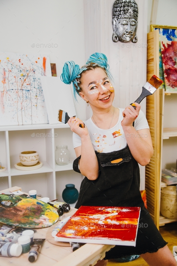 Artist girl painting of pictures in her art studio and smiling Stock ...