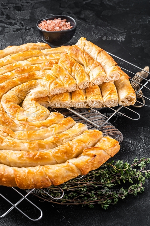 Turkish Tepsi Boregi, Round Borek cheese pie on kitchen board. Black ...