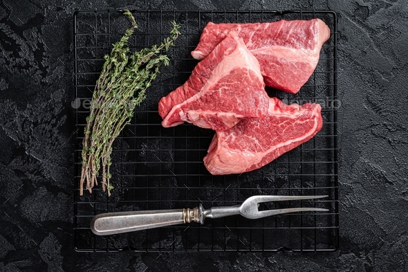 Topside sirloin beef cut, raw meat with spices. Black background. Top ...