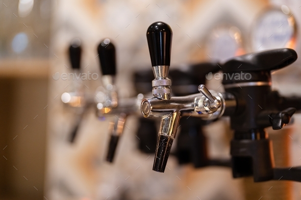 Drinks and beverages concept . Beer taps on blurred background Stock ...