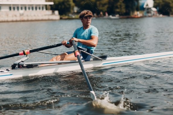 Sportsman single scull man rower rowing at competition boat regatta ...