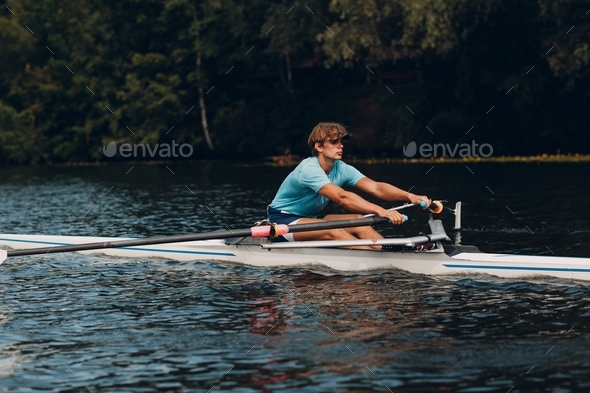 Sportsman single scull man rower rowing at competition boat regatta ...