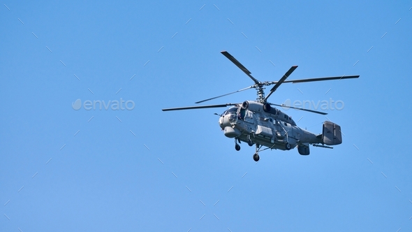Navy helicopter flying against blue sky background, copy space. One ...