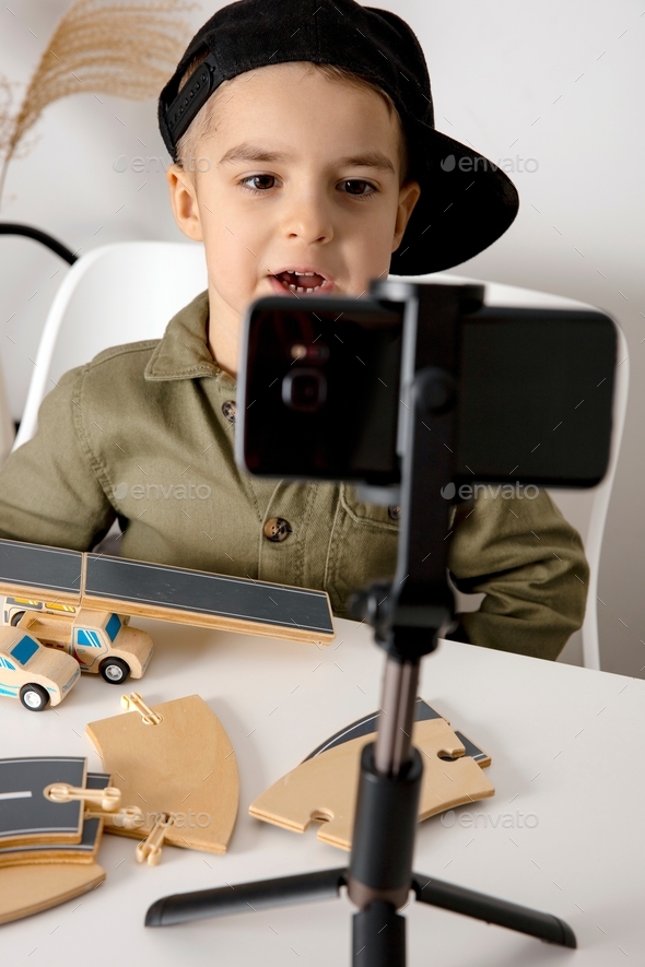 Adorable, cute, little boy blogger recording lifestyle blog, talking to ...