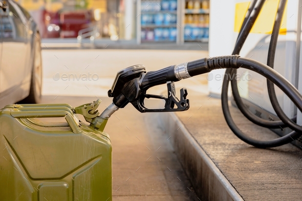 Refilling canister with fuel on the petrol station. Close up view. Fuel ...