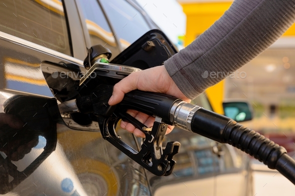 Car refuelling on the petrol station. Man refilling the car with fuel ...