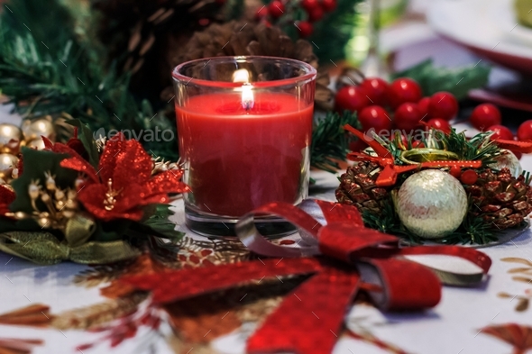 Christmas table decorated in red with a candlelight. Tablescape ...