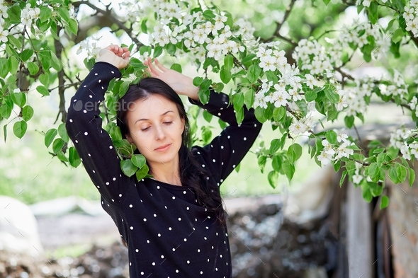 Aesthetic girl holds glass of flowers, spring blooming tree. Spring ...
