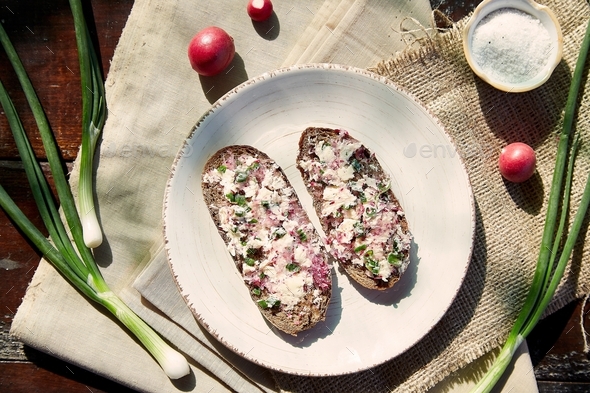 Smearing healthy radish on sourdough bread. Radish butter toast. Eat ...