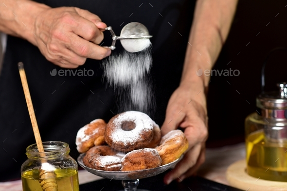 Homemade donuts. the chef sprinkles sugar powder on the donuts Stock ...