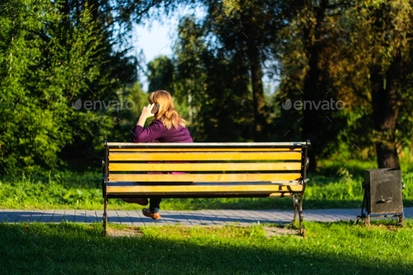 caucasian blond woman talking, speaking on the phone outside, outdoor ...