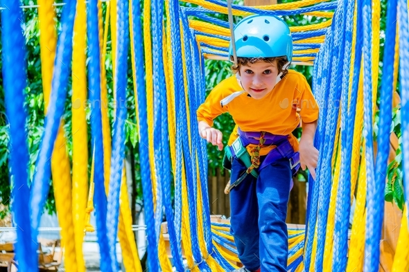 boy crossing an Course High Ropes Element in Adventure park Outdoor ...