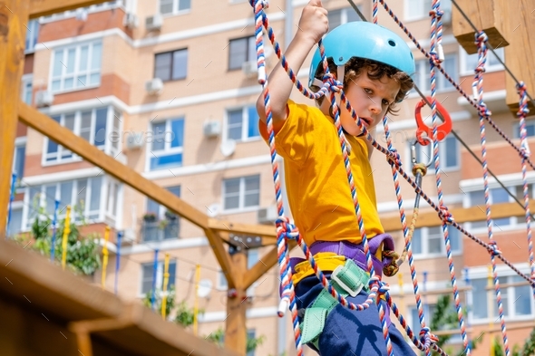 boy crossing an Course High Ropes Element in Adventure park Outdoor ...