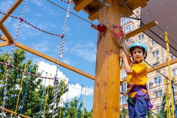 boy crossing an Course High Ropes Element in Adventure park Outdoor ...