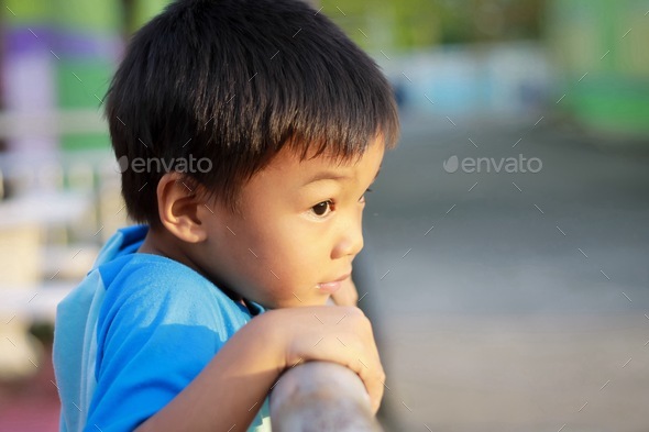 Sad Asian child boy. Thinking. Stock Photo by kookkaibuu | PhotoDune