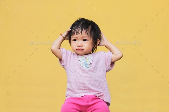 Moody. Angry child girl have a headache and crying. Stock Photo by ...