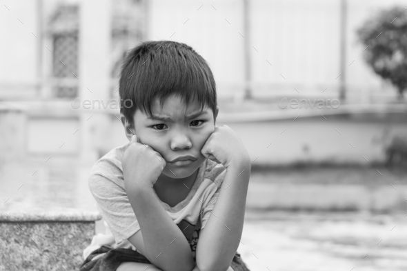 Asian child boy sad and angry. Moody emotion of kid. Black and white ...