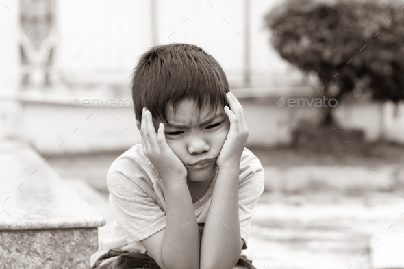 Alone Asian little boy feel sad, angry and stressed. He lonely at the ...