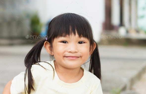Face of smile and laugh Asian girl in head shot. Happy kid playing at ...