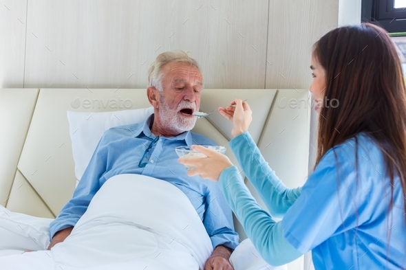 Caregiver nurse take care a Senior patient. Nurse helping senior Man ...