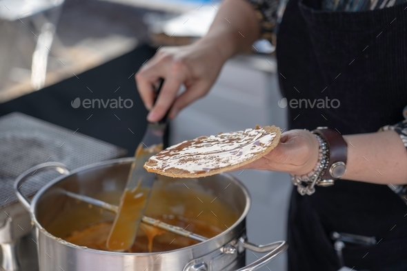 lady at local markets making stroopwafel/ dutch waffles with syrup ...