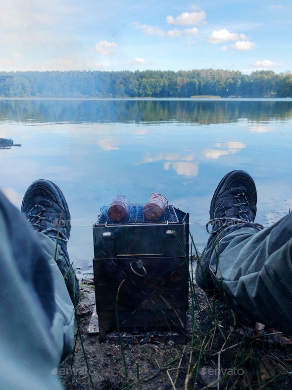 Barbecue next to a lake - first perspective view Stock Photo by nicgorski