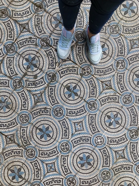 female legs and a floor from a multi-colored tile Stock Photo by Les_am
